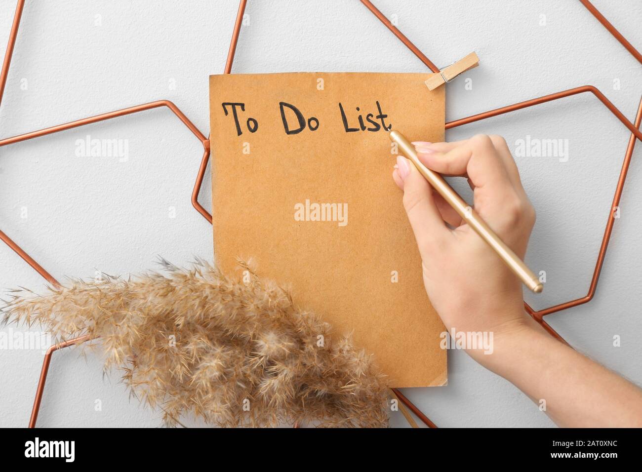 Woman making to do list on white background Stock Photo - Alamy