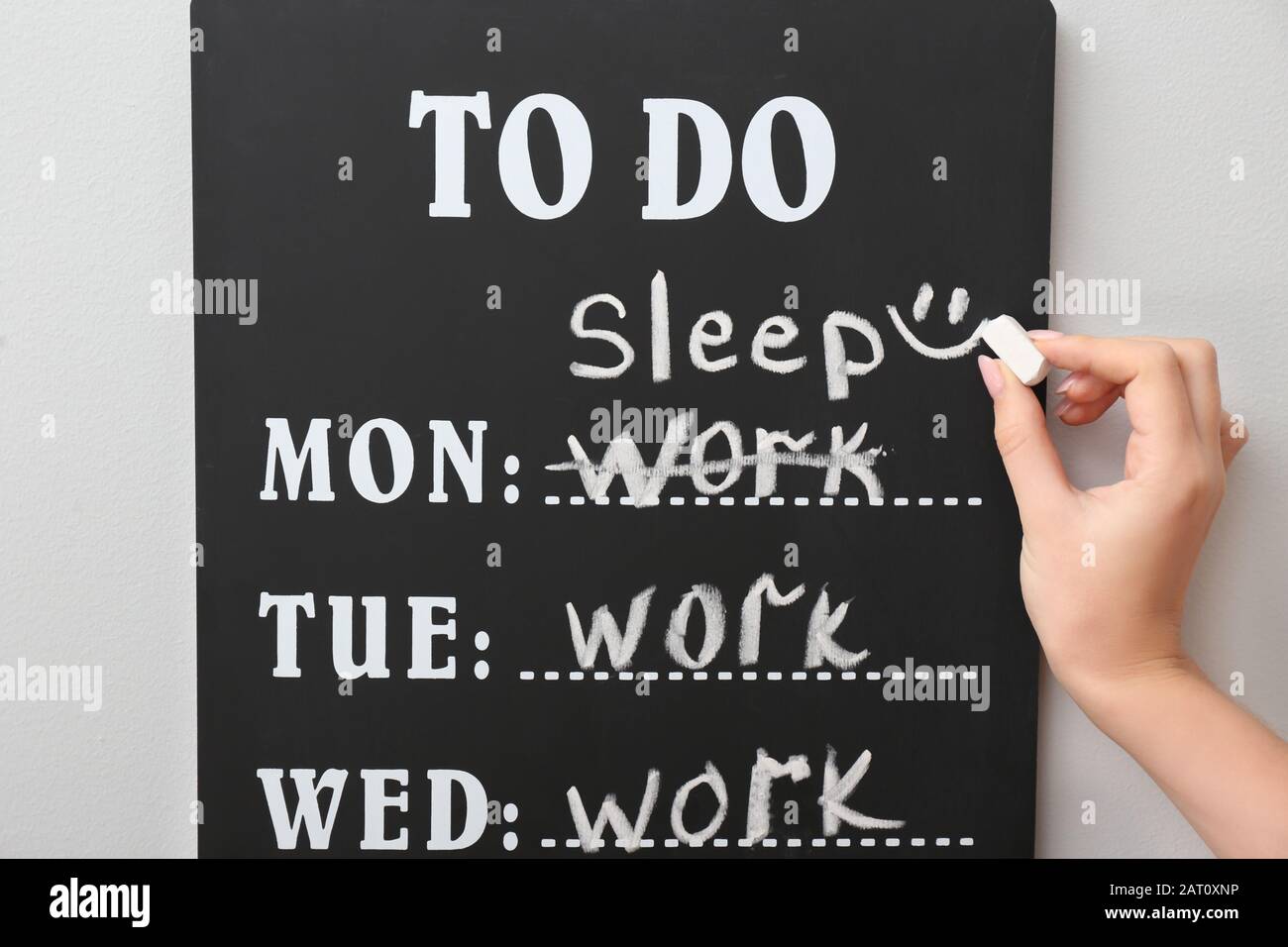 Woman making to do list on white background Stock Photo - Alamy