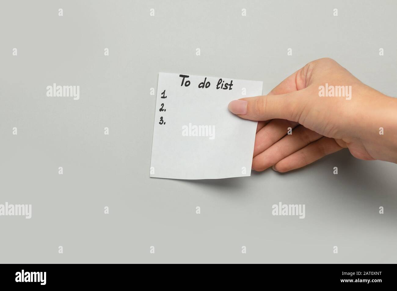 Woman making to do list on white background Stock Photo - Alamy