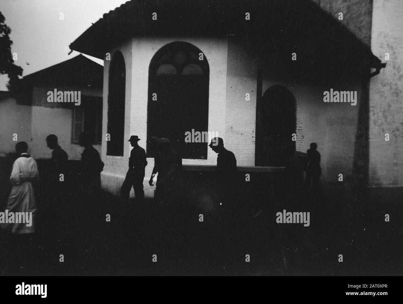 [a military funeral procession leaves a Roman Catholic church ...