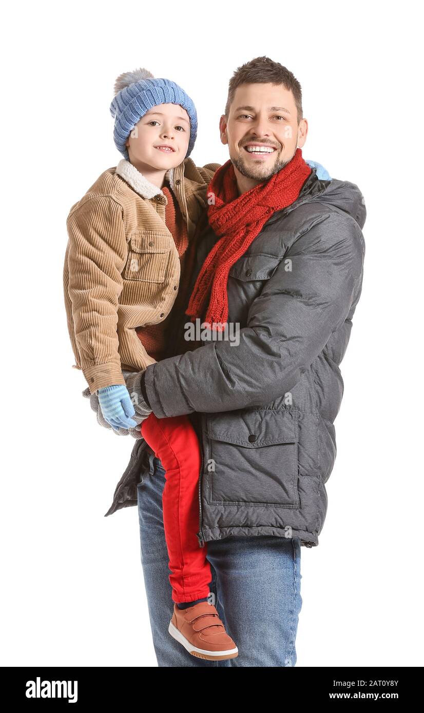 Cute little boy with father in winter clothes on white background Stock ...
