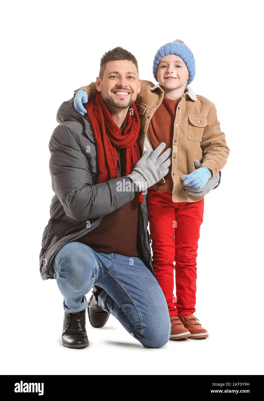 Cute little boy with father in winter clothes on white background Stock ...