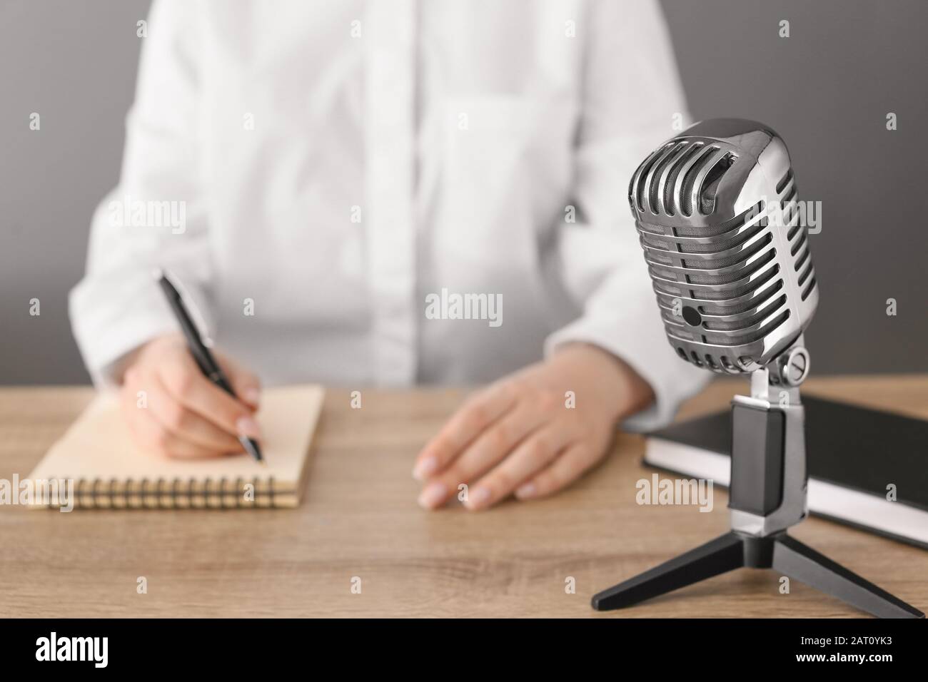 Female journalist with microphone having an interview in office ...