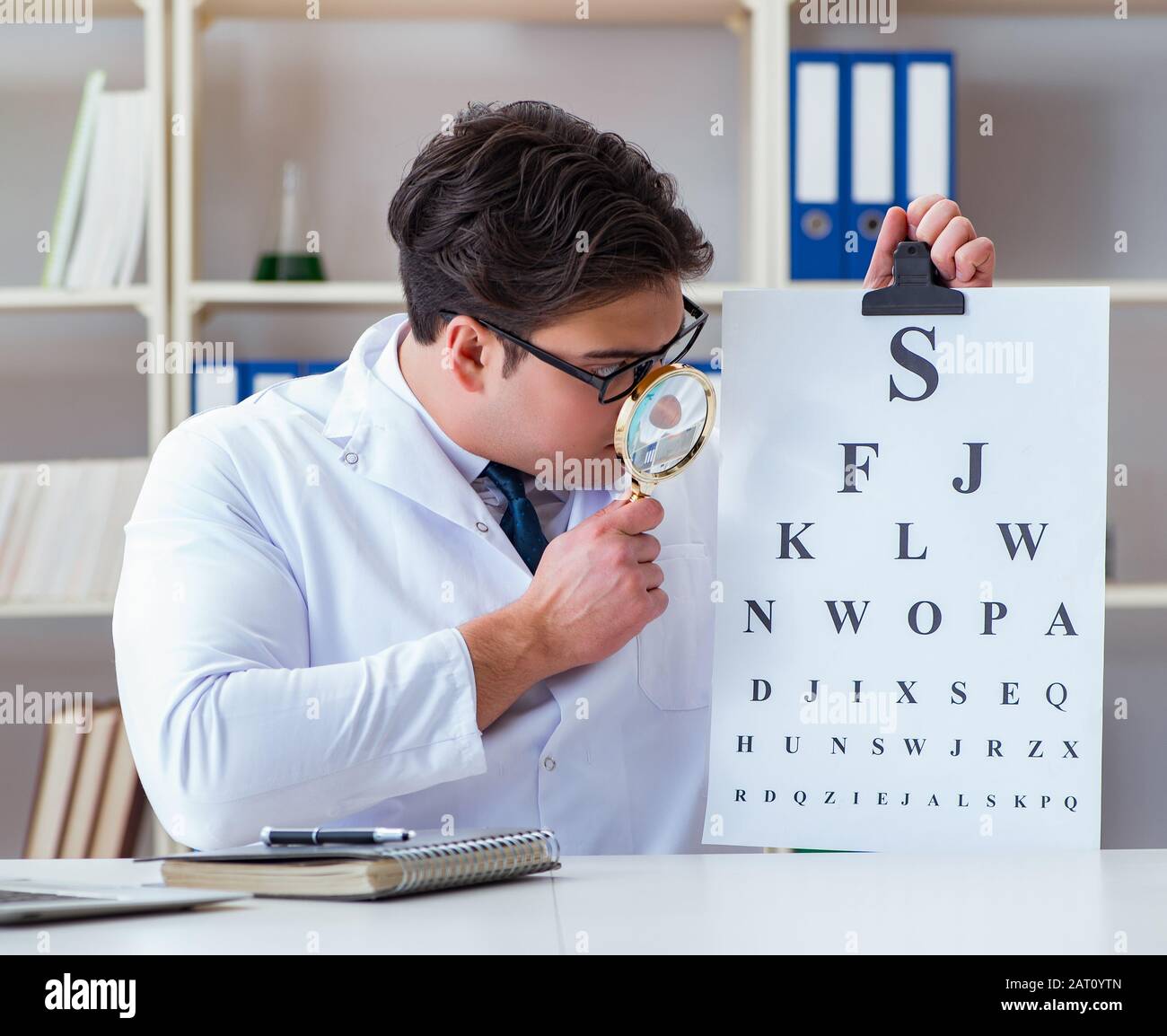 The doctor optician with letter chart conducting an eye test check ...