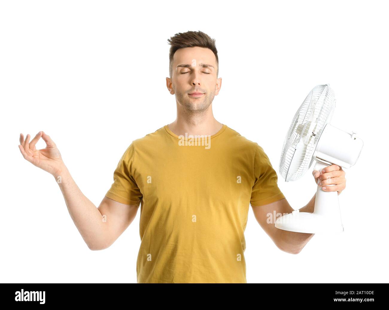 Relaxing man with electric fan on white background Stock Photo - Alamy
