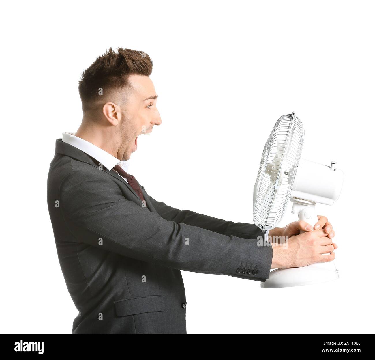 Happy man with electric fan on white background Stock Photo - Alamy