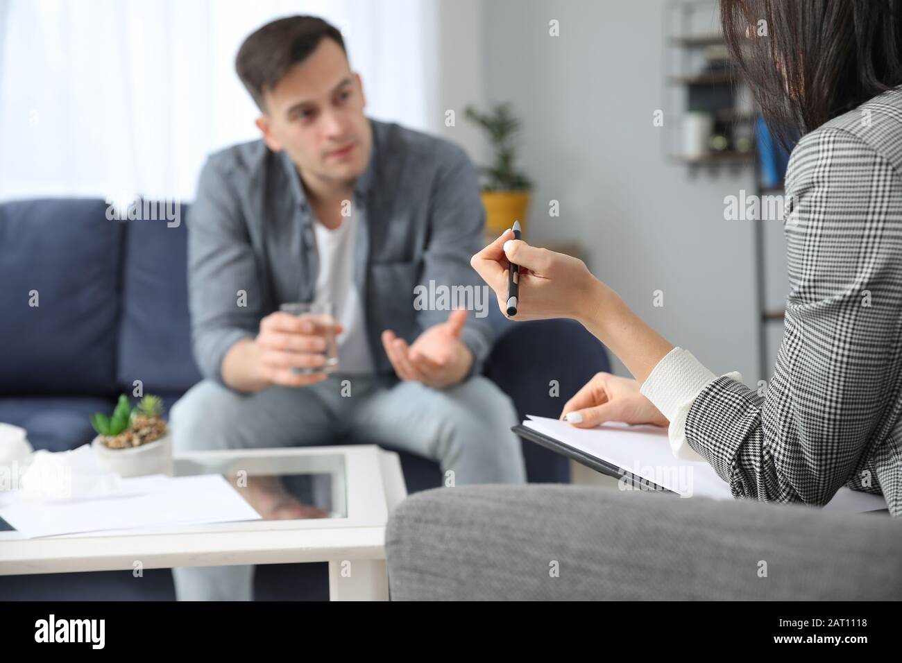 Psychologist working with patient in office Stock Photo - Alamy