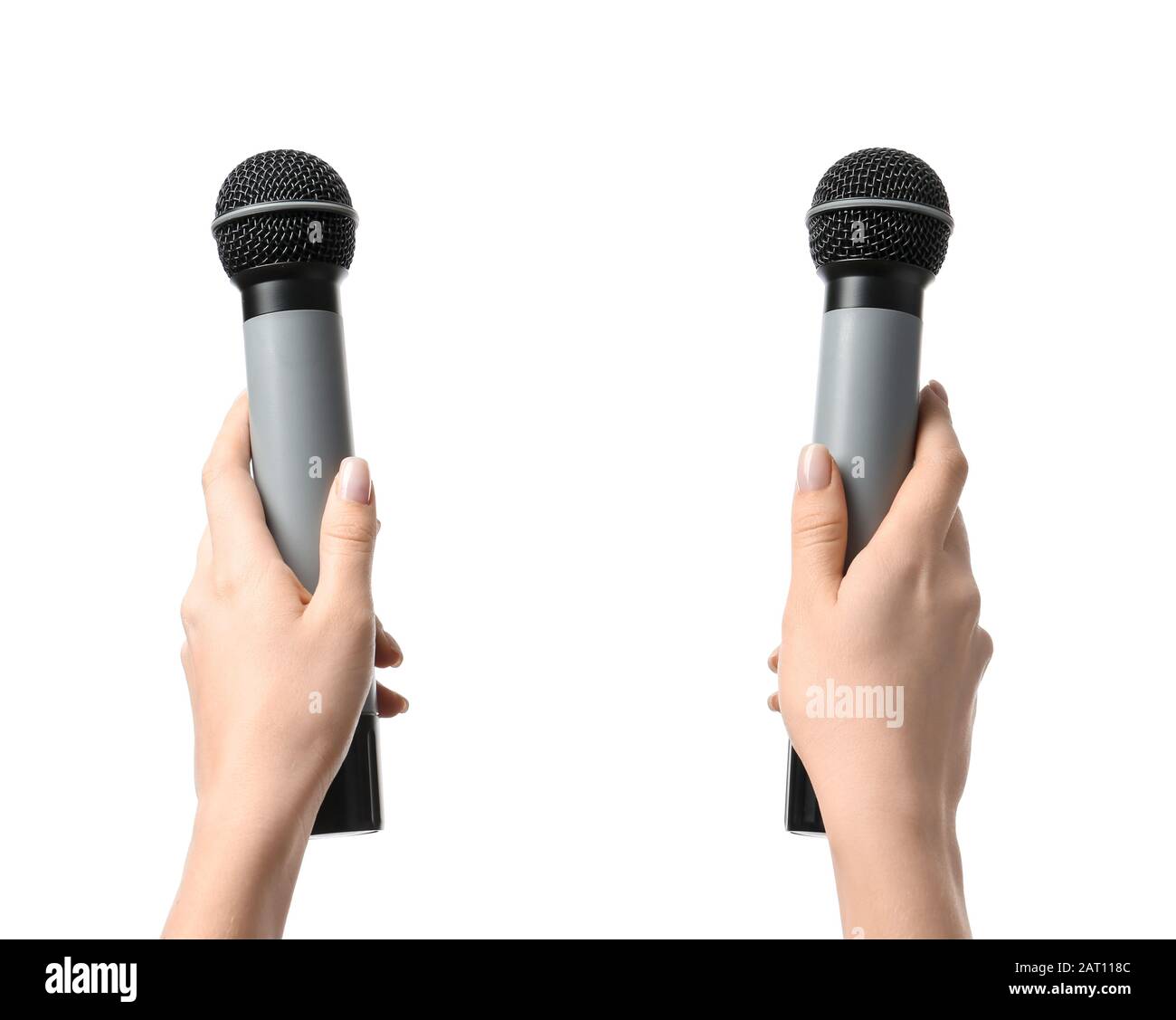 Female hands with microphones on white background Stock Photo - Alamy
