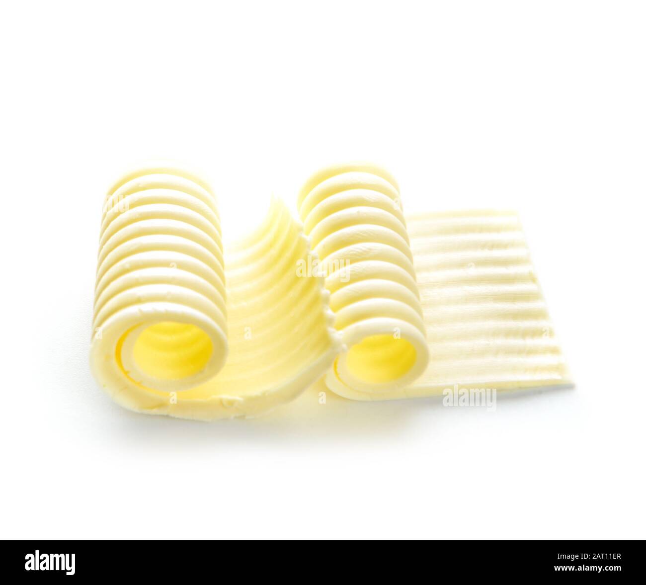 Curls of fresh butter on white background Stock Photo - Alamy