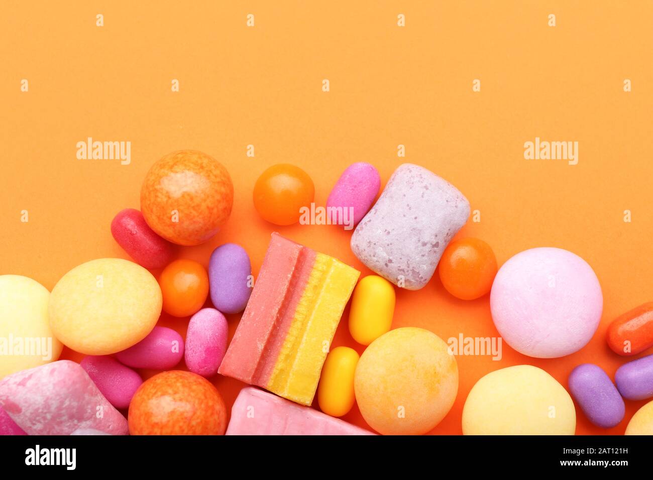 Different chewing gums on color background Stock Photo - Alamy