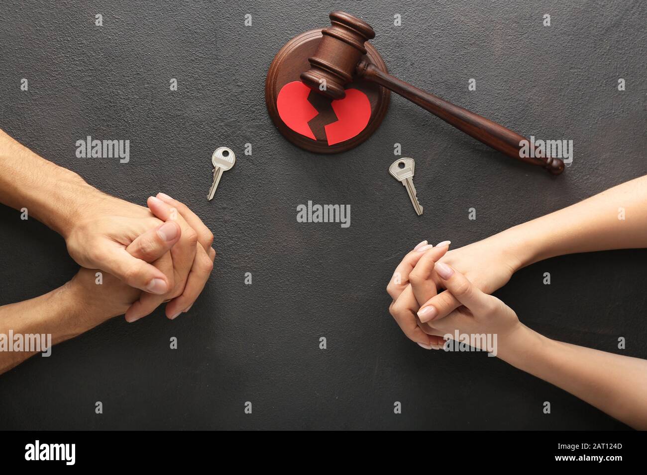 Hands of couple with keys and judge's gavel on dark background. Concept ...