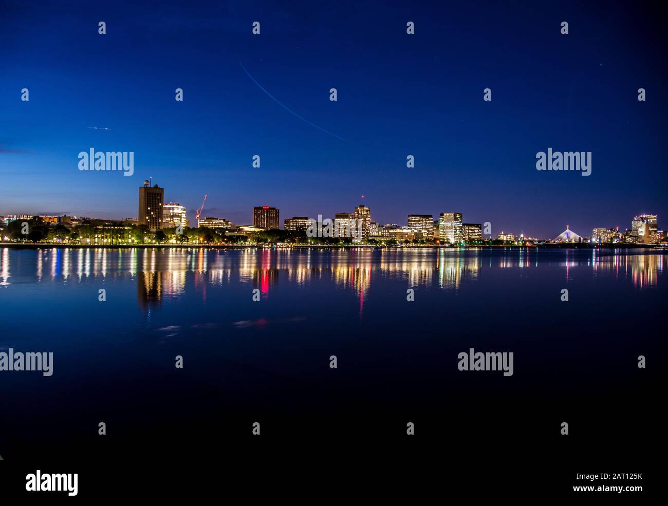 Charles River in Boston reflecting buildings after sunset. City lights ...