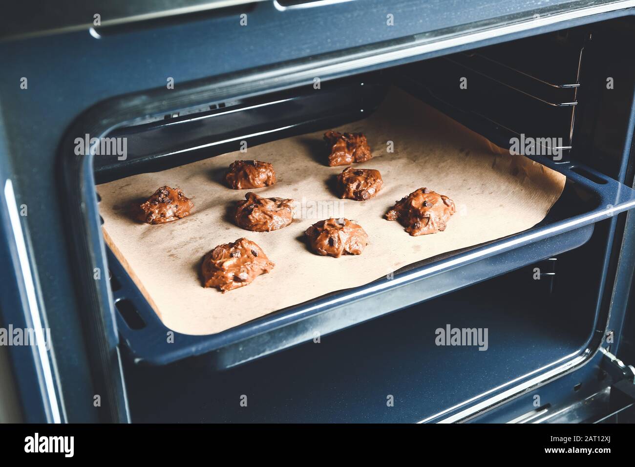 Baking tray with raw cookies in oven Stock Photo - Alamy