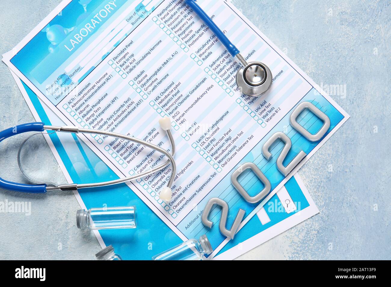 Stethoscope, laboratory test form and figure 2020 on color background ...