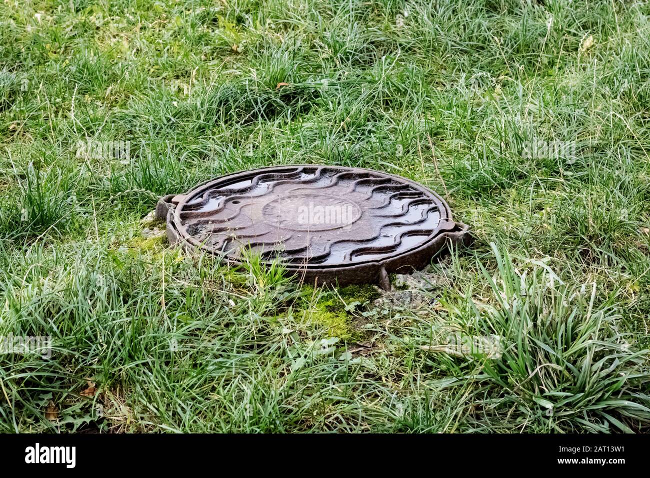 Manhole cover round of grass cover hi-res stock photography and images ...