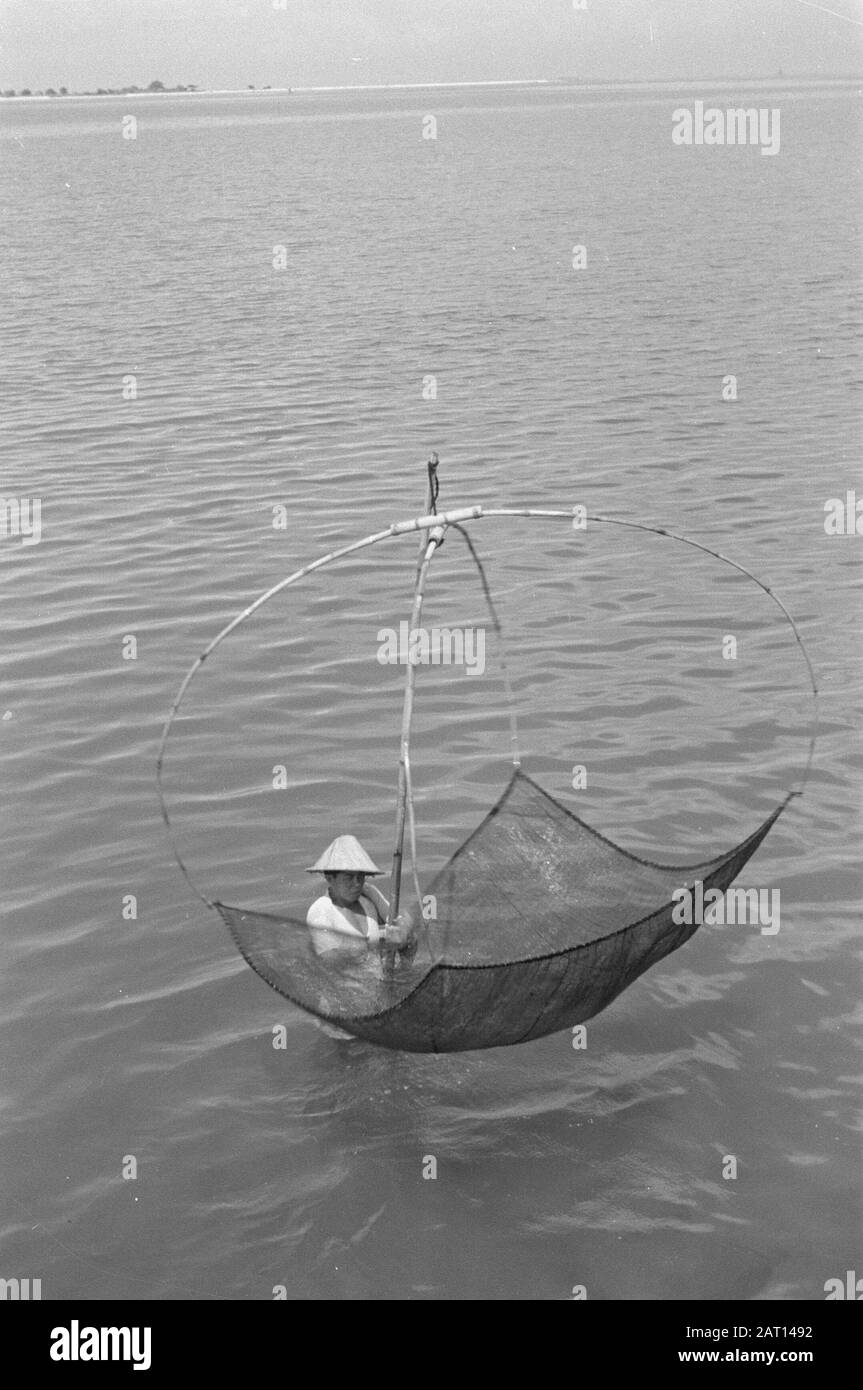 Makassar, Morotai, Ambon A fisherman wades through the water Date: 22 ...