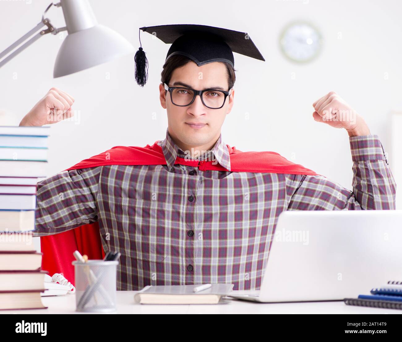 The super hero student wearing a mortarboard studying for exams Stock ...