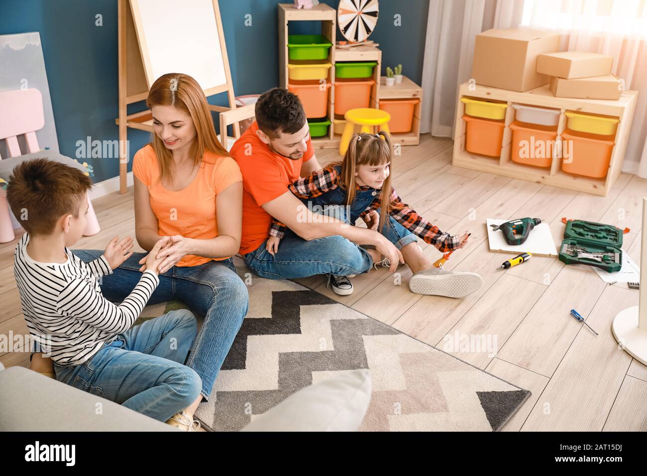 Family assembling furniture at home Stock Photo - Alamy