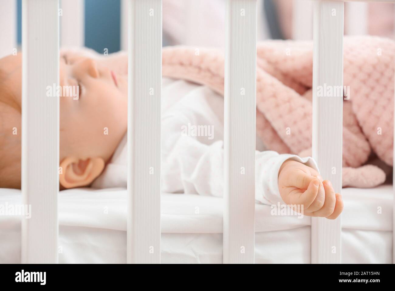 Little baby sleeping in bed, view through railing Stock Photo - Alamy