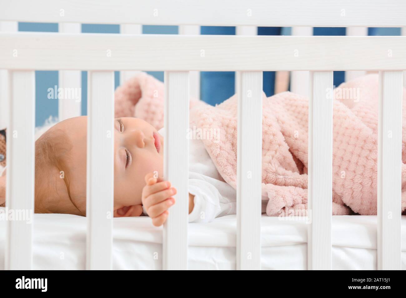 Little baby sleeping in bed, view through railing Stock Photo - Alamy