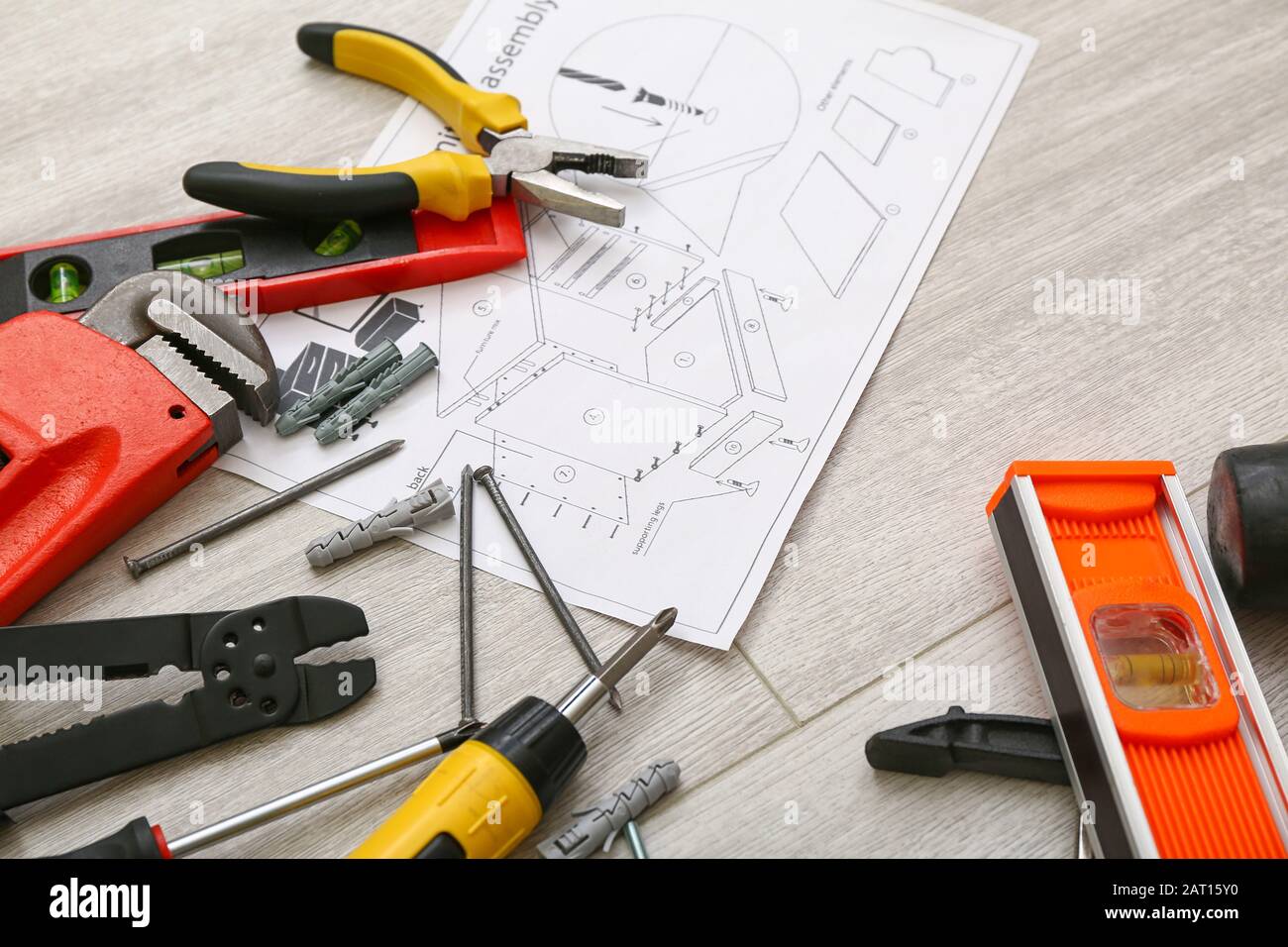 Furniture assembling plan with set of tools on table Stock Photo - Alamy