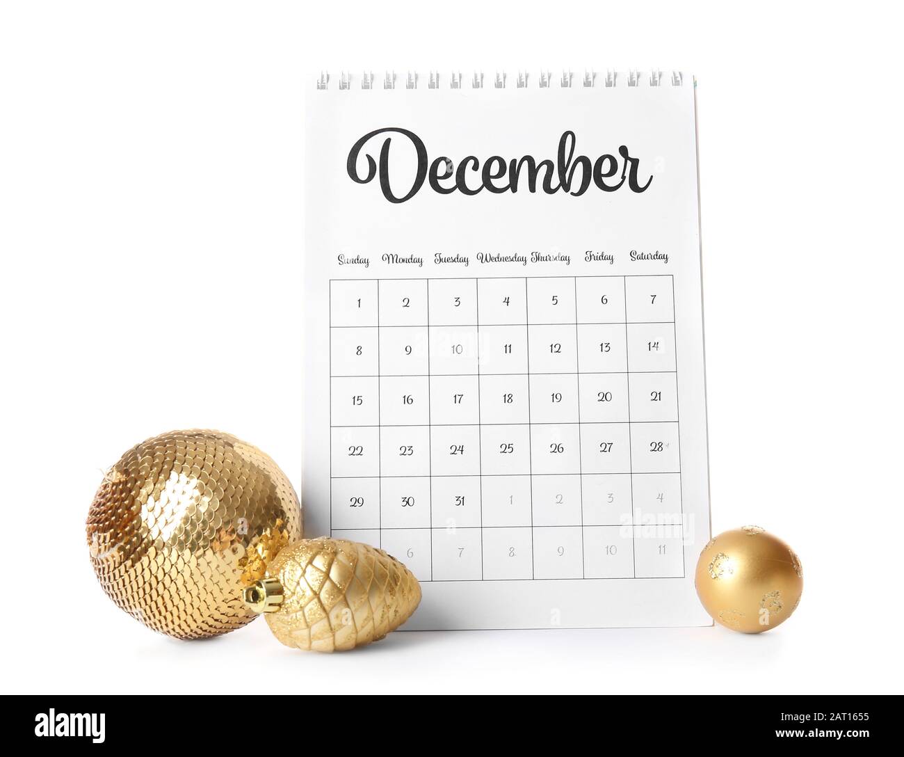Calendar with page of December and Christmas decor on white background ...