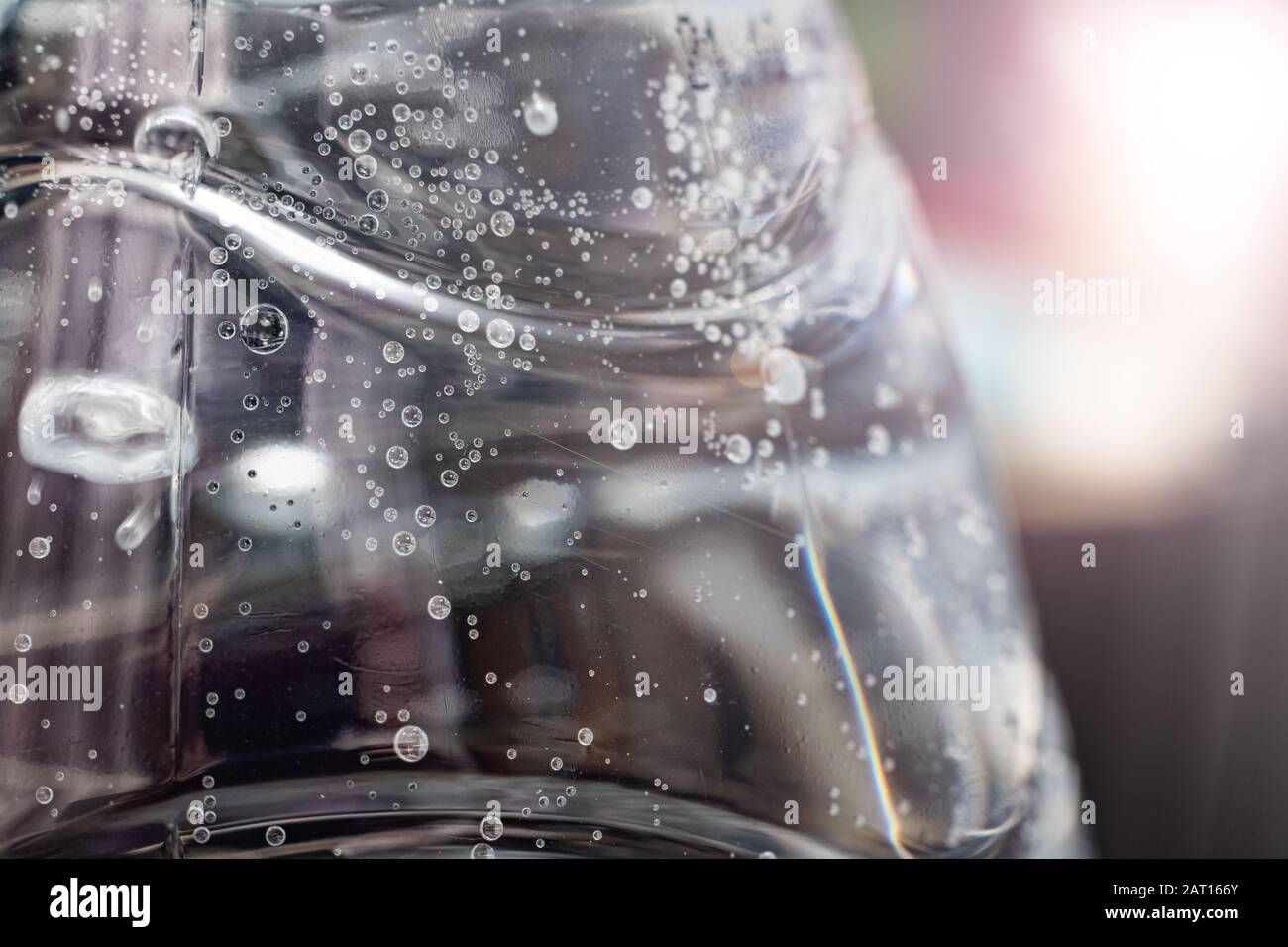 Bubbles in a water bottle in sunlight Stock Photo - Alamy
