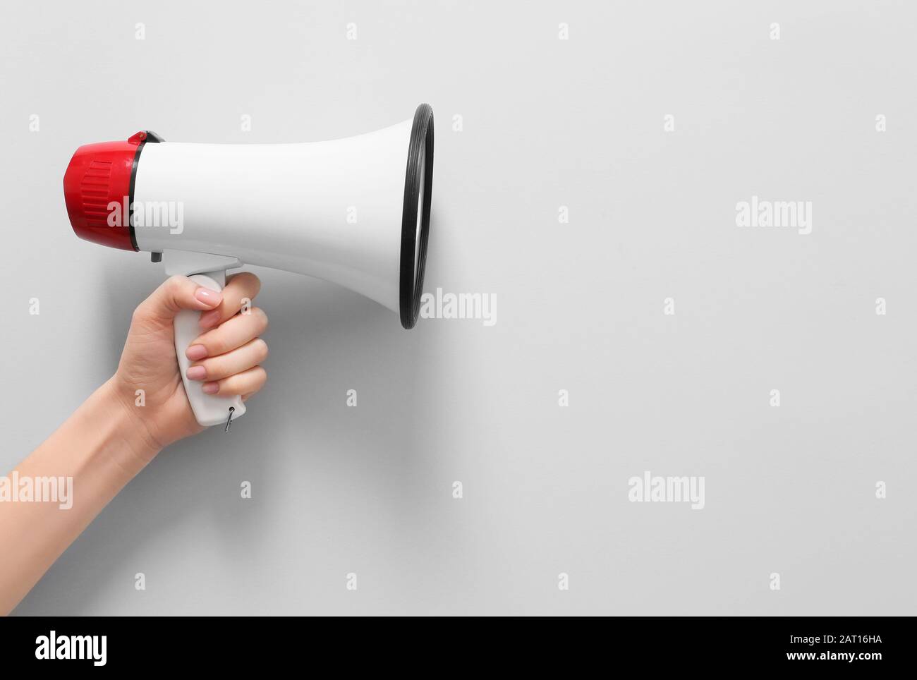 Female hand with megaphone on white background Stock Photo - Alamy