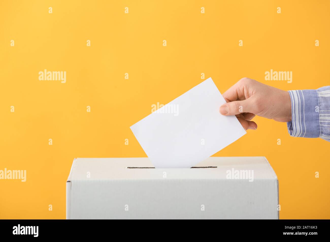 Voting woman near ballot box on color background Stock Photo - Alamy