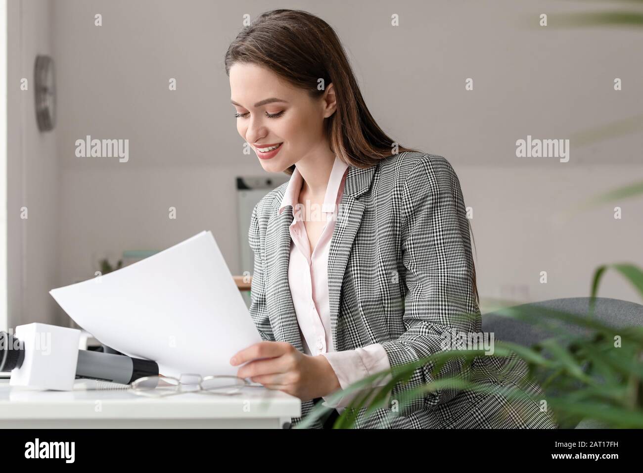 Female journalist working in office Stock Photo - Alamy