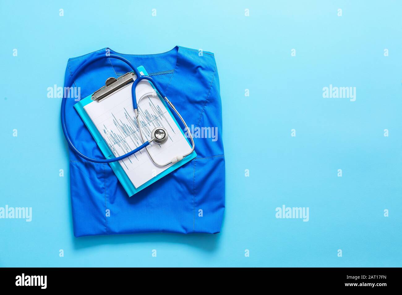 Stethoscope, doctor's uniform and documents on color background ...