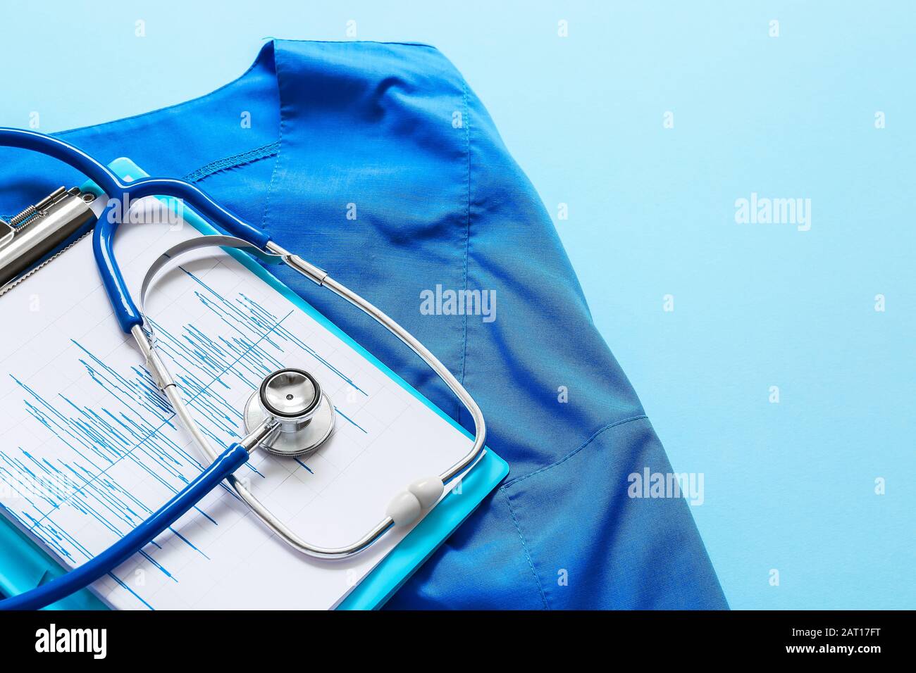 Stethoscope, doctor's uniform and documents on color background ...