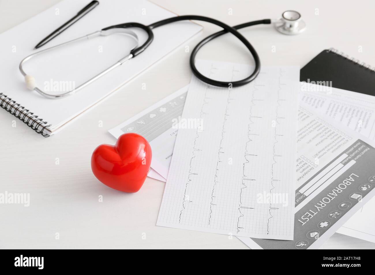 Stethoscope, cardiogram, laboratory test form and heart on doctor's ...