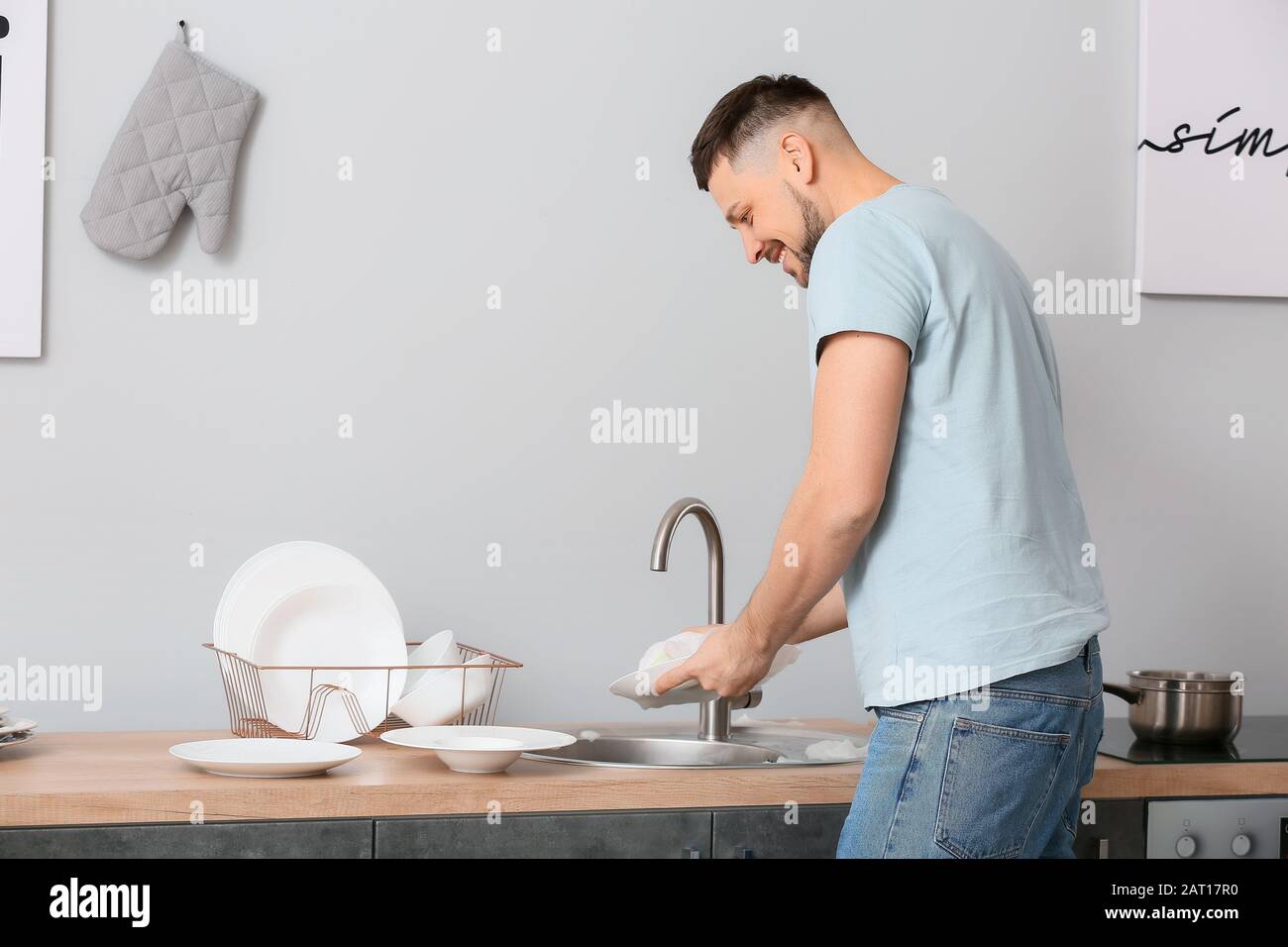 Man washing dishes in kitchen hi-res stock photography and images - Alamy