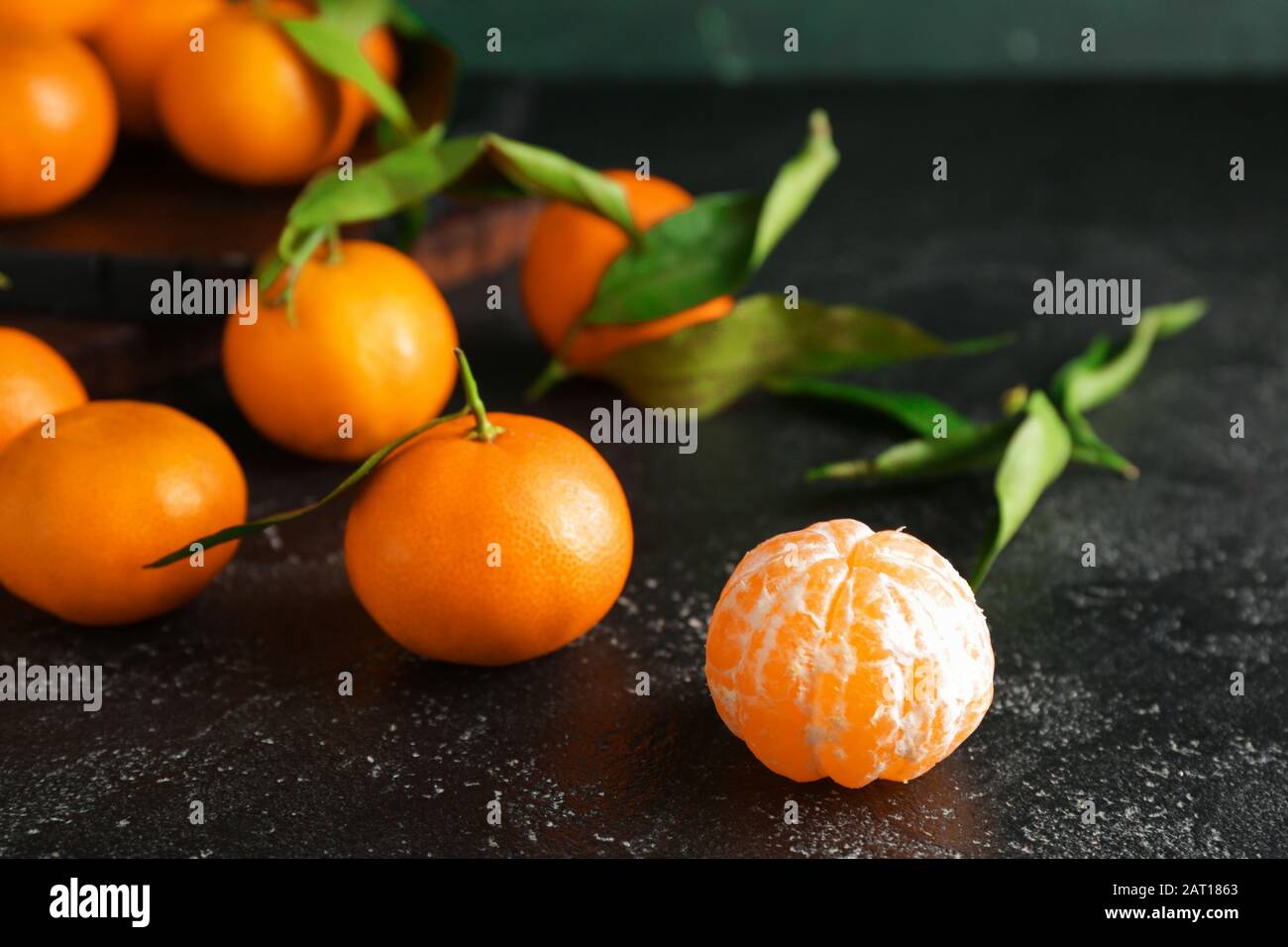 Sweet tangerines on dark table Stock Photo - Alamy