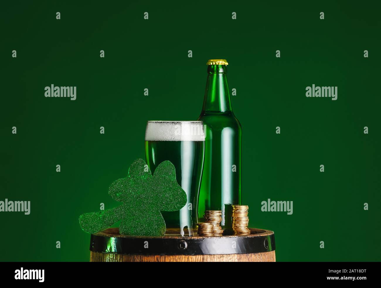Green beer, coins and barrel on dark background. St. Patrick's Day ...