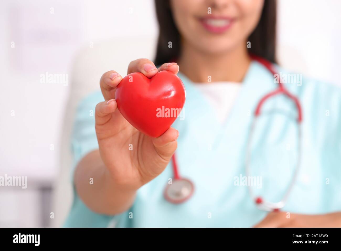 Female cardiologist with red heart in modern clinic, closeup Stock ...