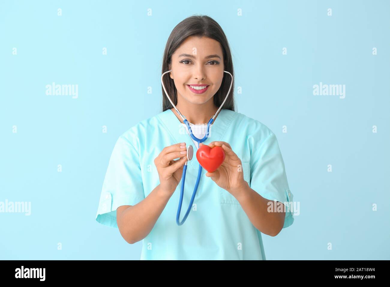 Female cardiologist on color background Stock Photo - Alamy