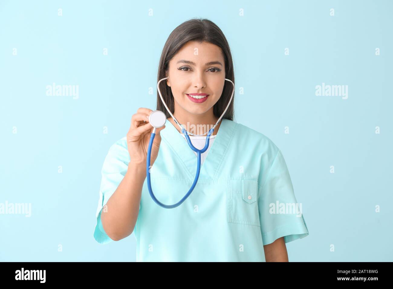 Female cardiologist on color background Stock Photo - Alamy