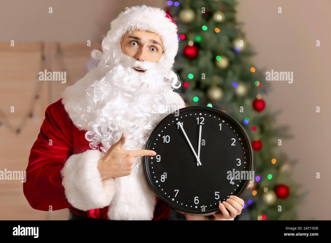 Santa Claus with clock in room. Christmas countdown concept Stock Photo ...
