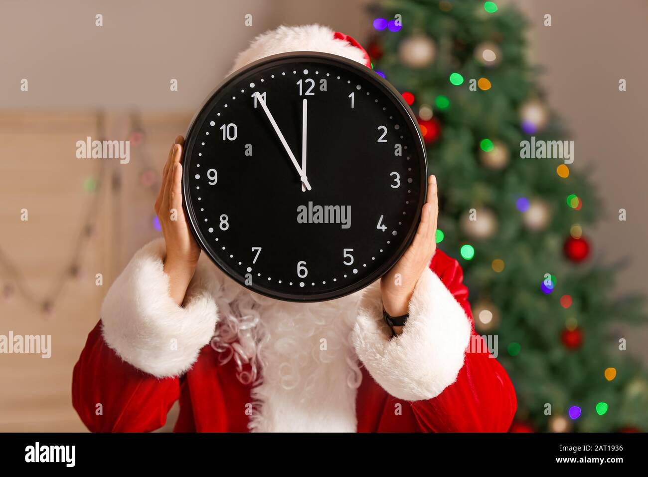 Santa Claus with clock in room. Christmas countdown concept Stock Photo ...