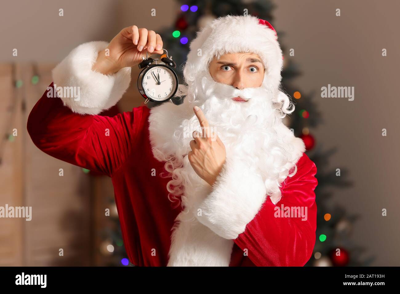 Santa with alarm clock in room. Christmas countdown concept Stock Photo ...