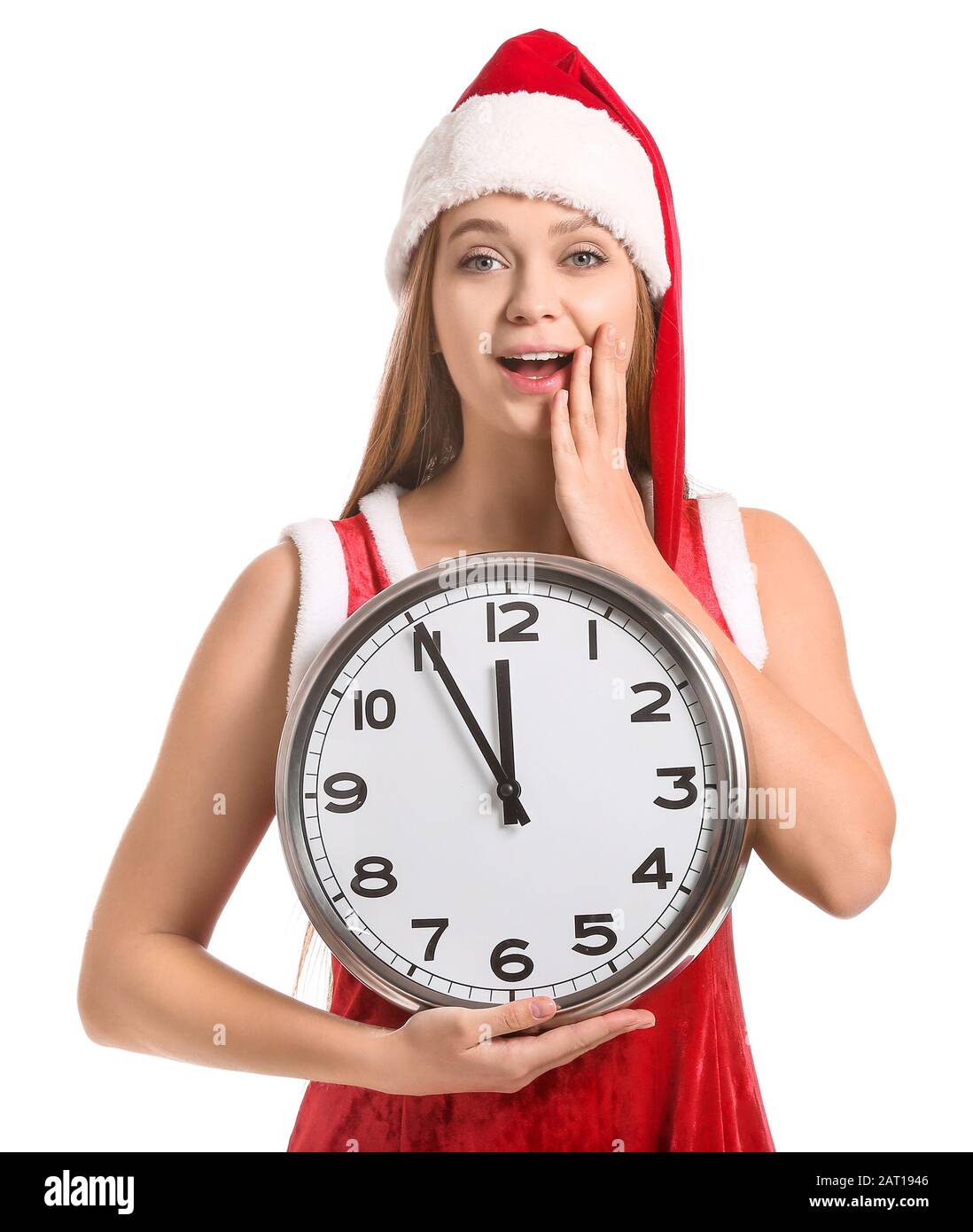 Surprised young woman in Santa costume and with clock on white ...