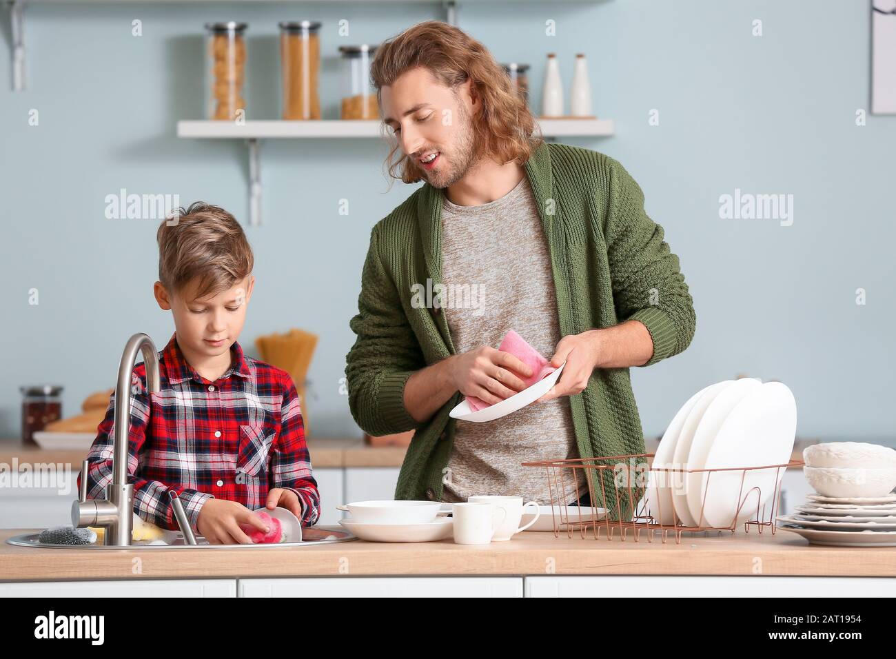 Father and son washing up the dishes hi-res stock photography and ...