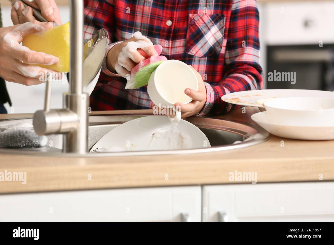 Father and son washing dishes in kitchen, closeup Stock Photo - Alamy