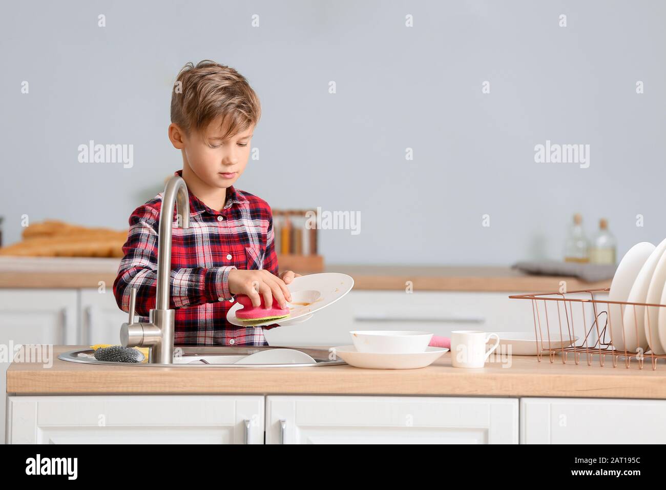 Boy washing dishes hi-res stock photography and images - Alamy