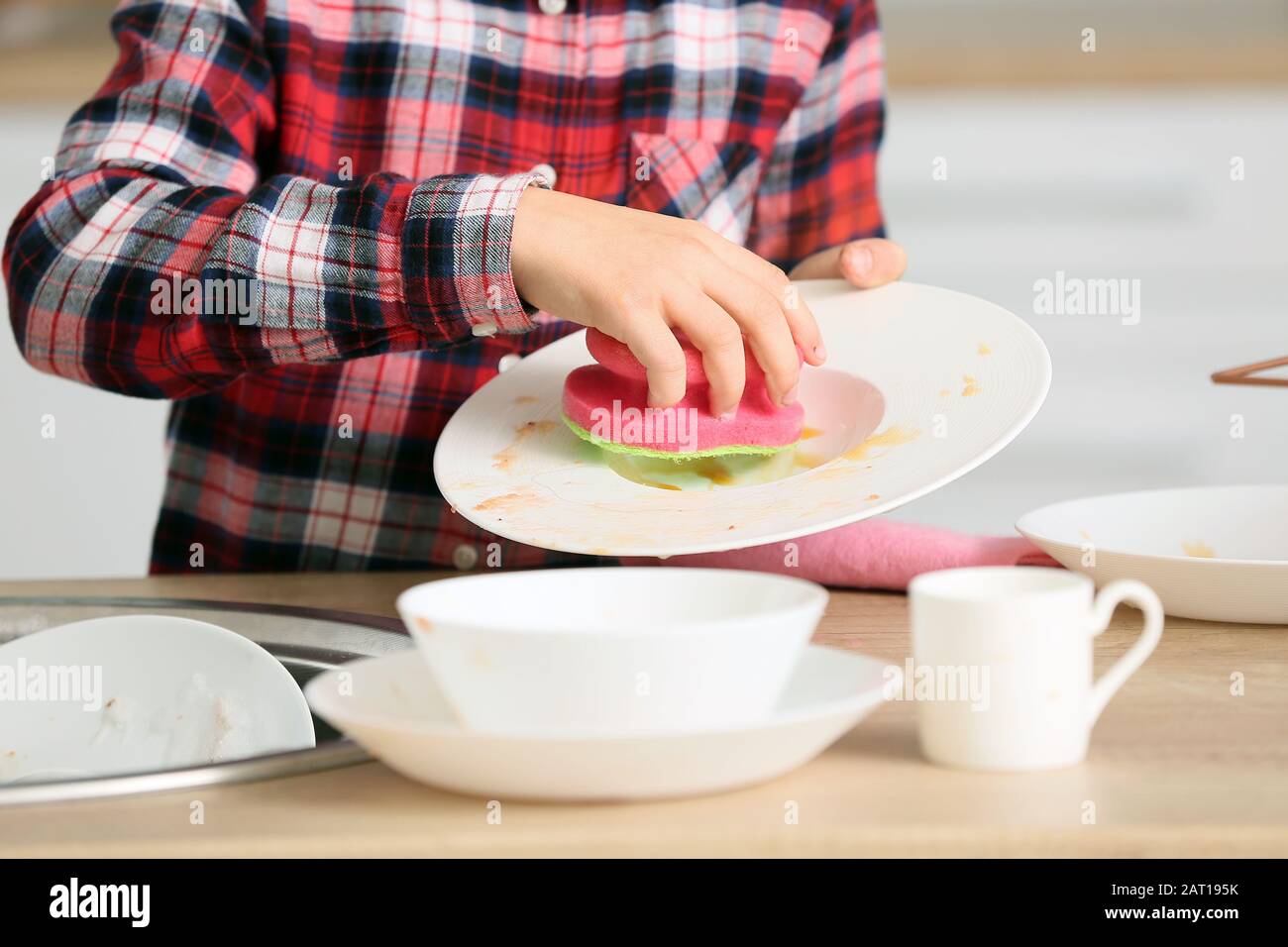 Little boy washing dishes in kitchen, closeup Stock Photo - Alamy