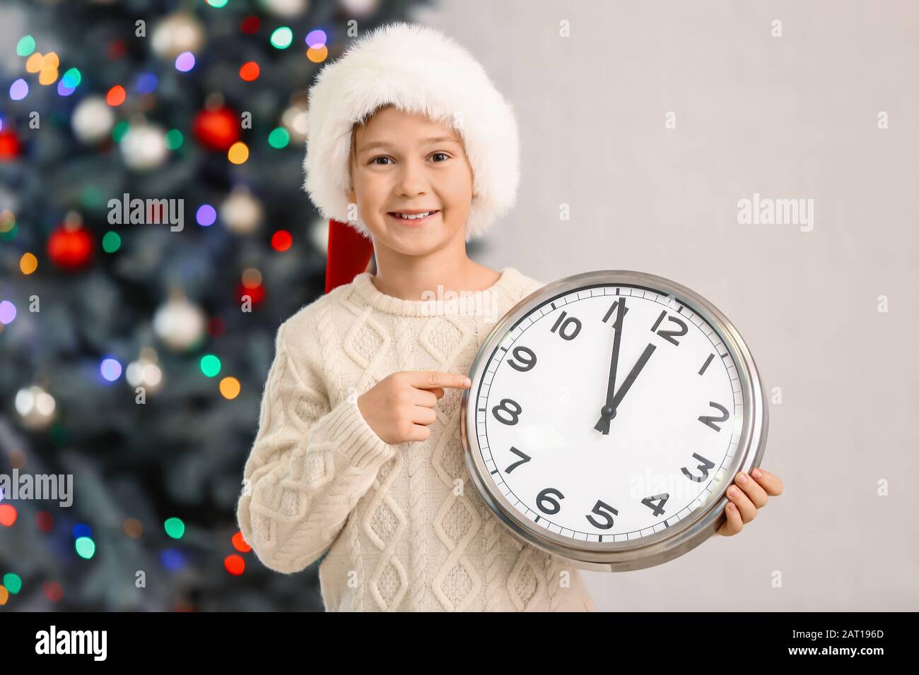 Little boy with clock at home. Christmas countdown concept Stock Photo ...