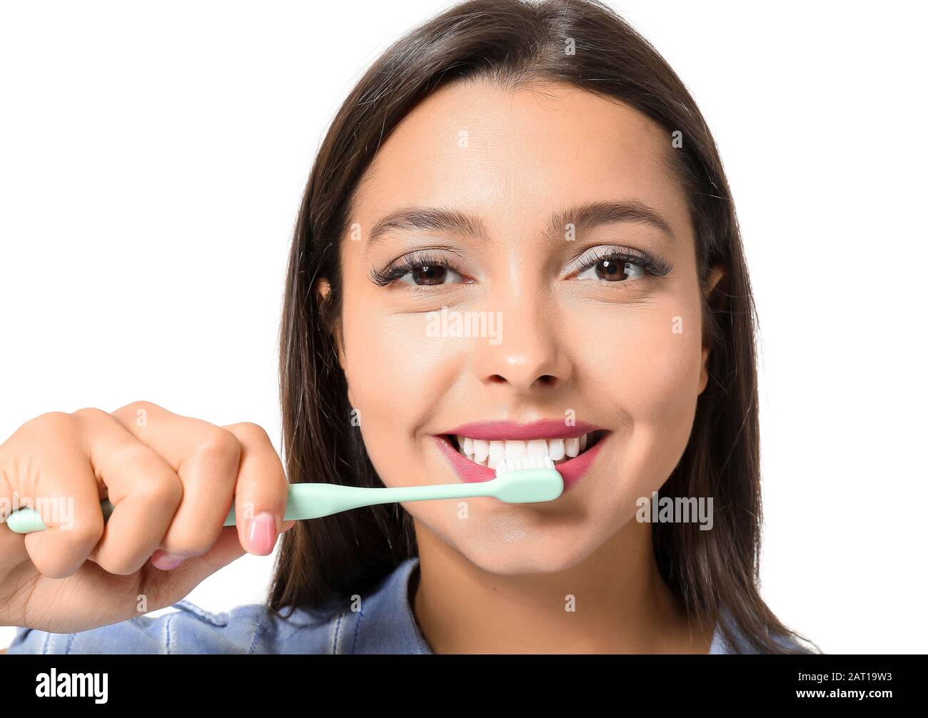 Beautiful woman brushing teeth on white background Stock Photo - Alamy