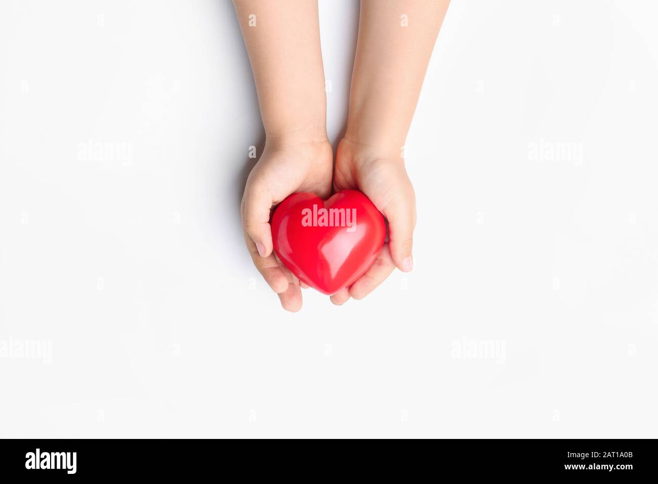 Child hands with red heart on white background. Cardiology concept ...